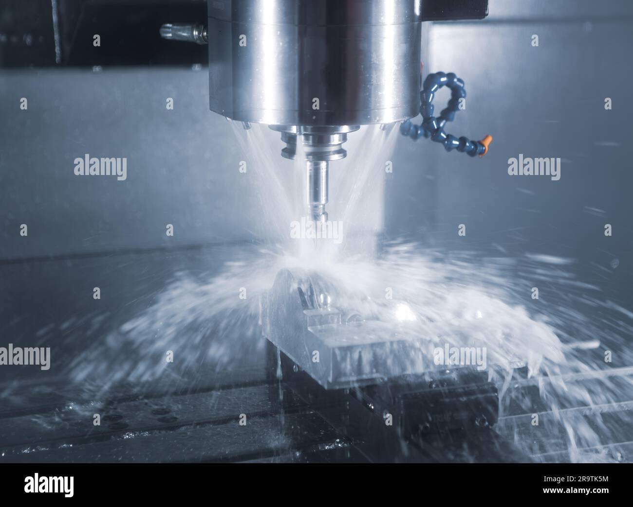 High precision CNC milling machine cutting workpiece with coolant ...