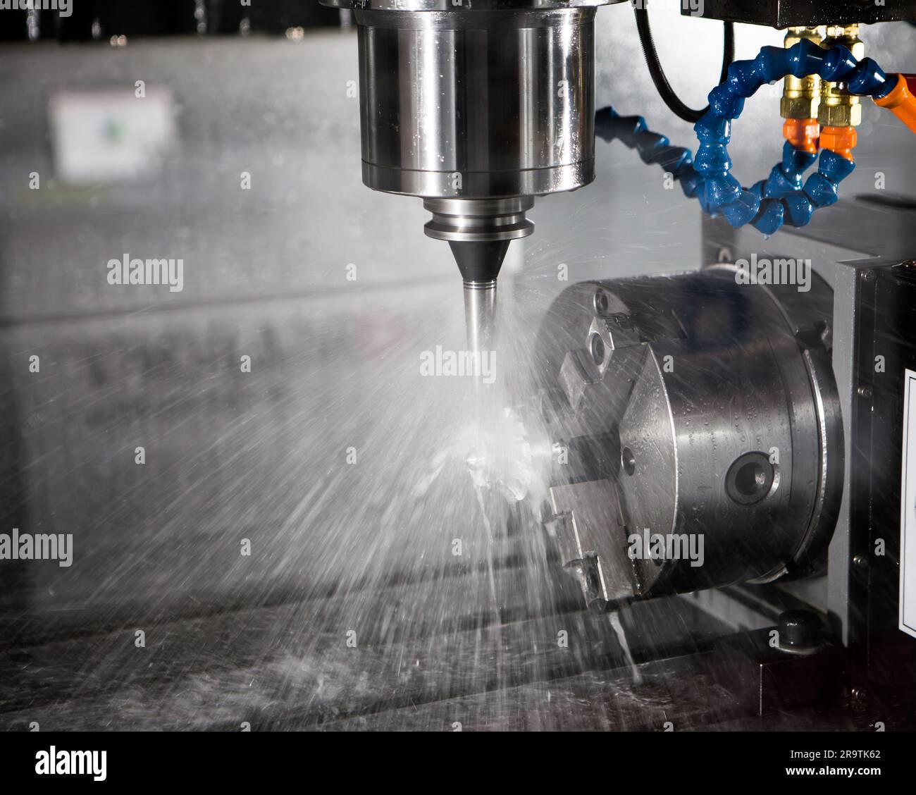 High precision CNC milling machine cutting workpiece with coolant ...