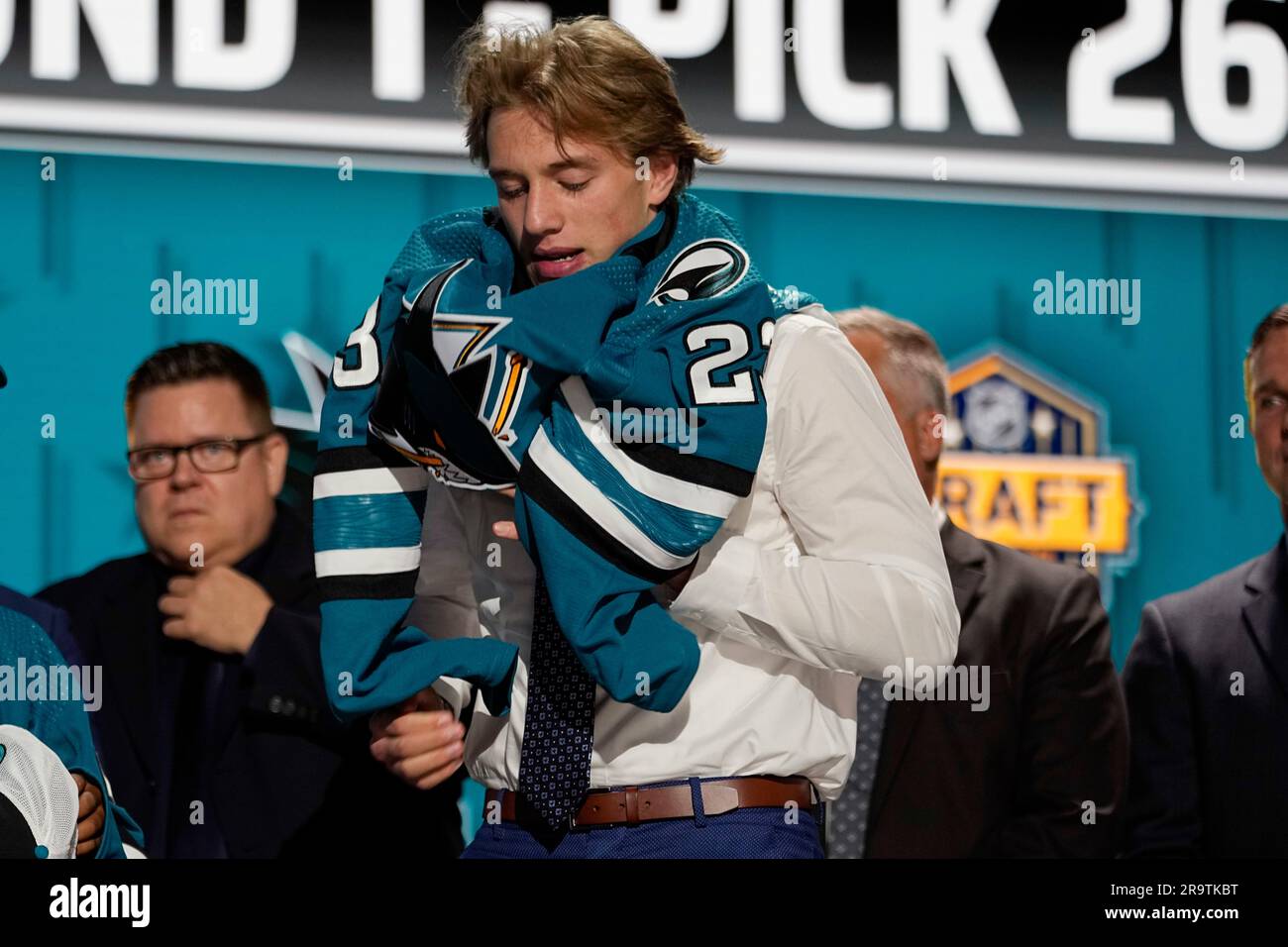 Quentin Musty puts on a San Jose Sharks jersey after being picked by ...