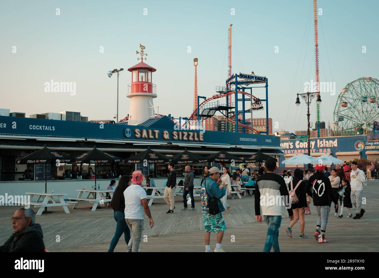 Salt & Sizzle and people on the boardwalk in Coney Island, Brooklyn ...