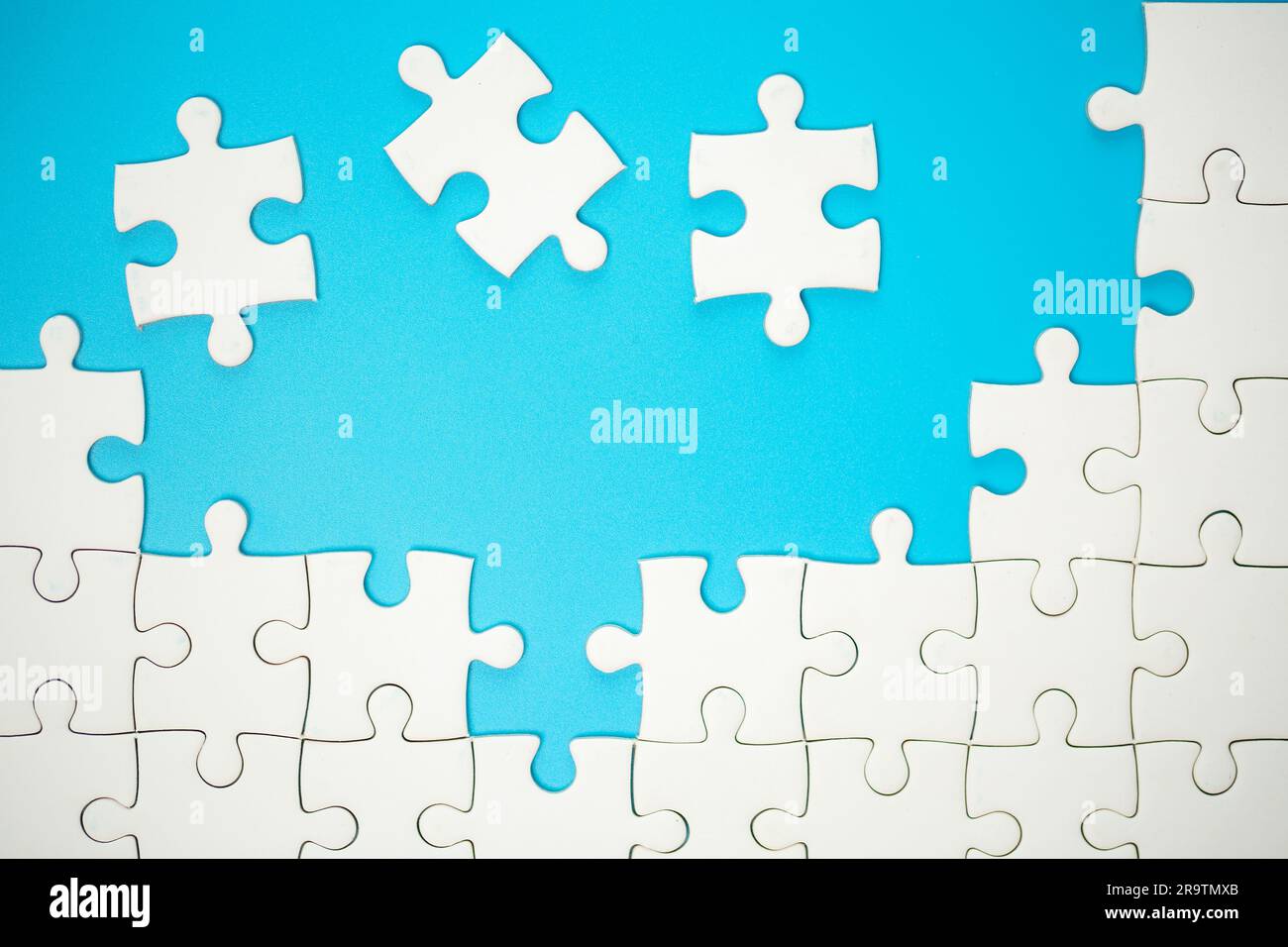 White part of jigsaw puzzle pieces on blue background. concepts of ...