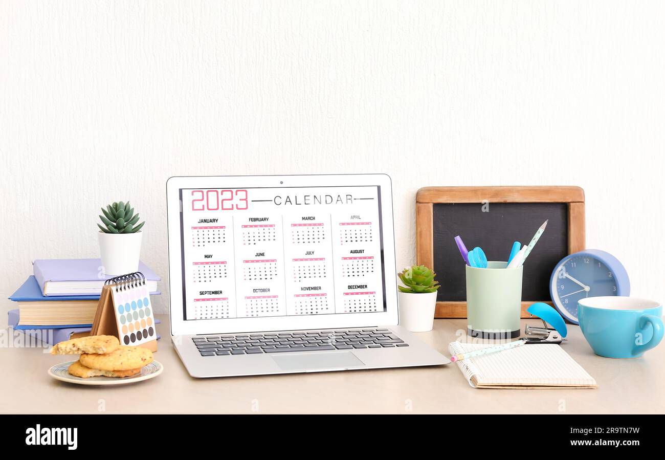 Modern laptop with calendar at workplace Stock Photo - Alamy