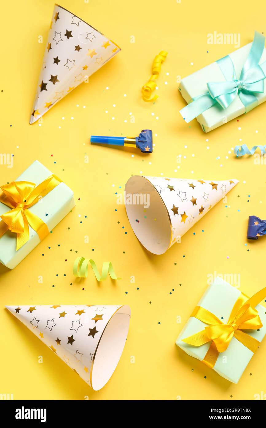 Different party decor on yellow background Stock Photo - Alamy