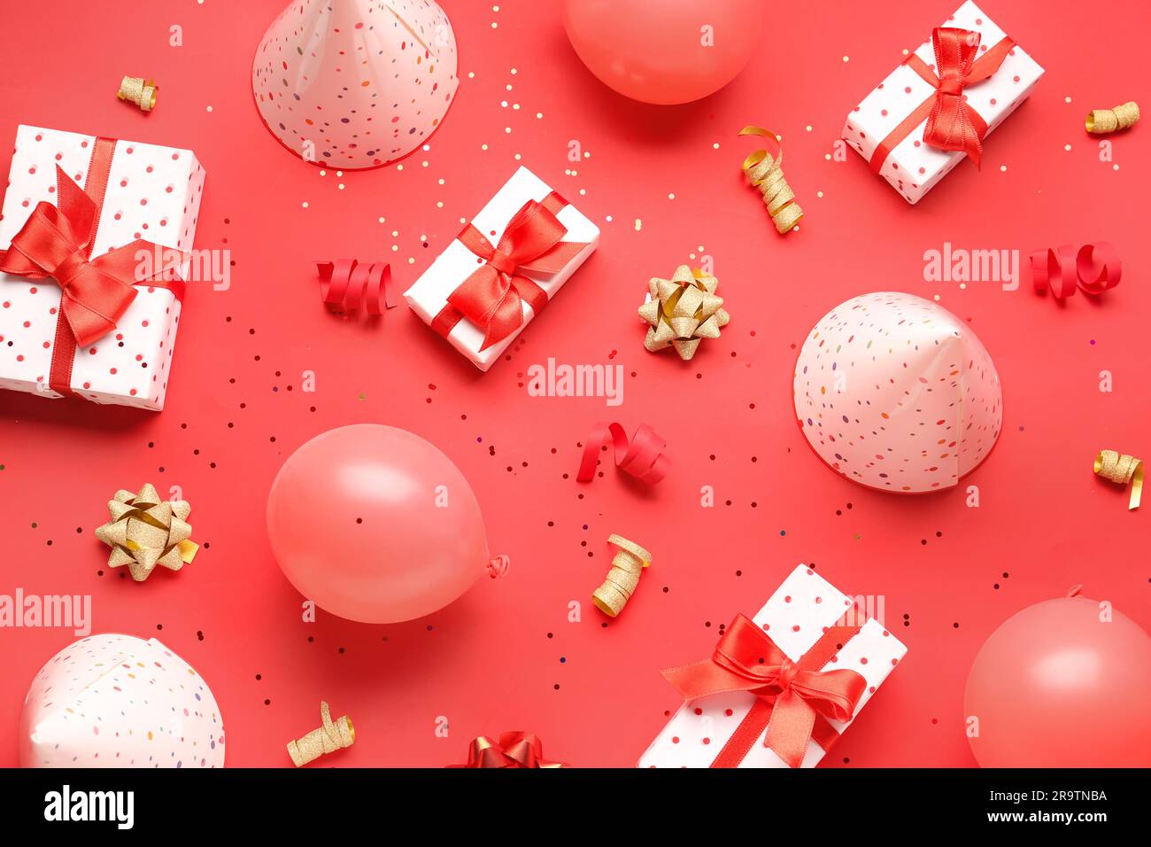 Different party decor on red background Stock Photo - Alamy