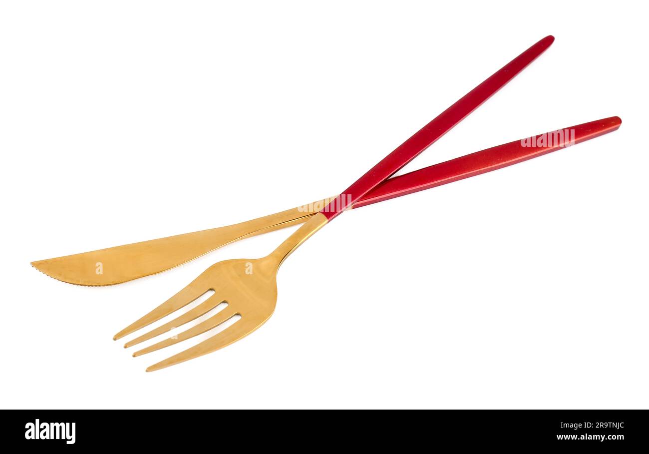 Golden fork and knife with red handles on white background Stock Photo ...