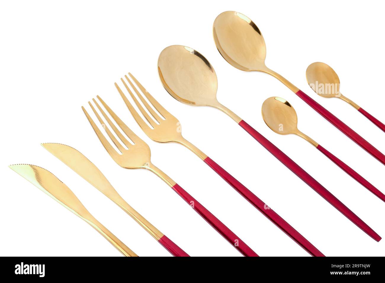 Golden set of cutlery with red handles on white background Stock Photo ...