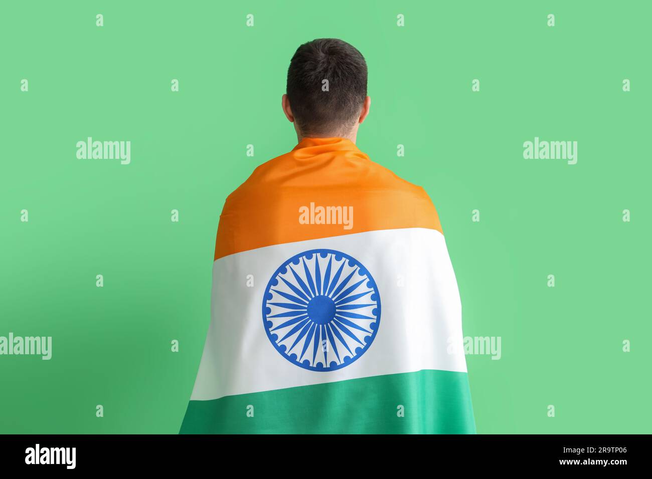Young man with Indian flag on green background, back view Stock Photo ...