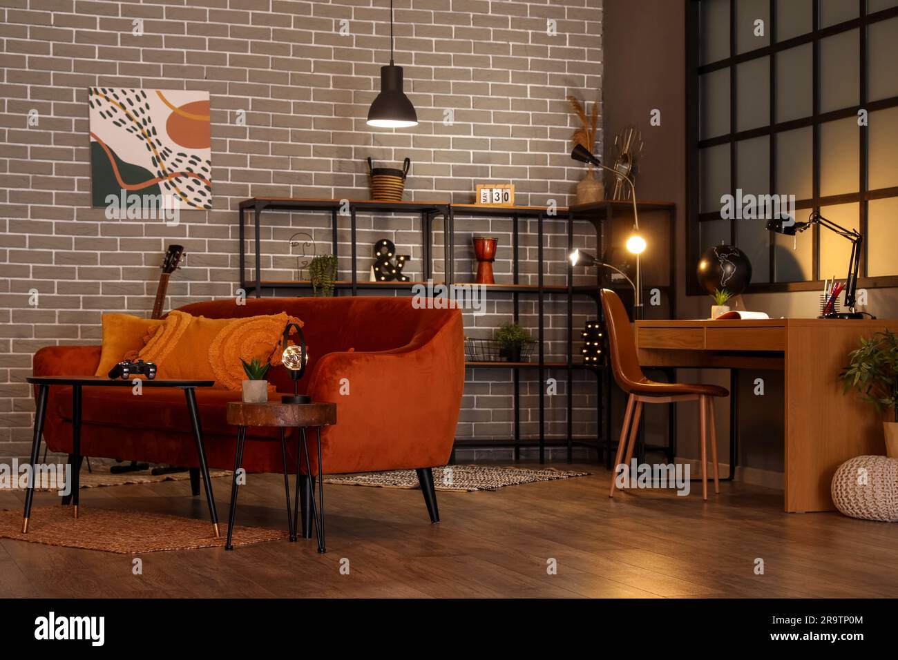Interior of dark room with glowing lamps, sofa and workplace Stock ...