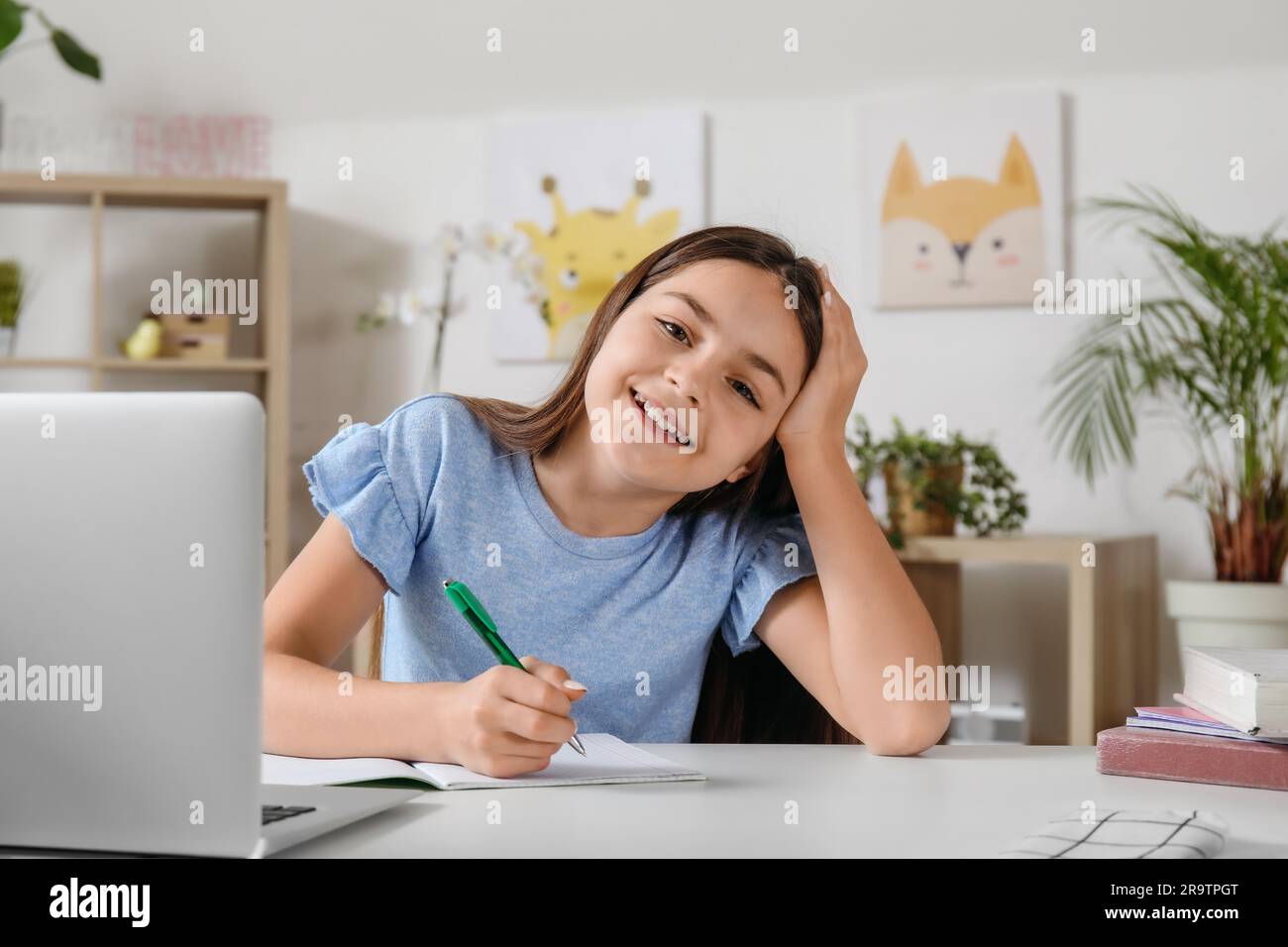 Little girl doing lessons at home Stock Photo - Alamy