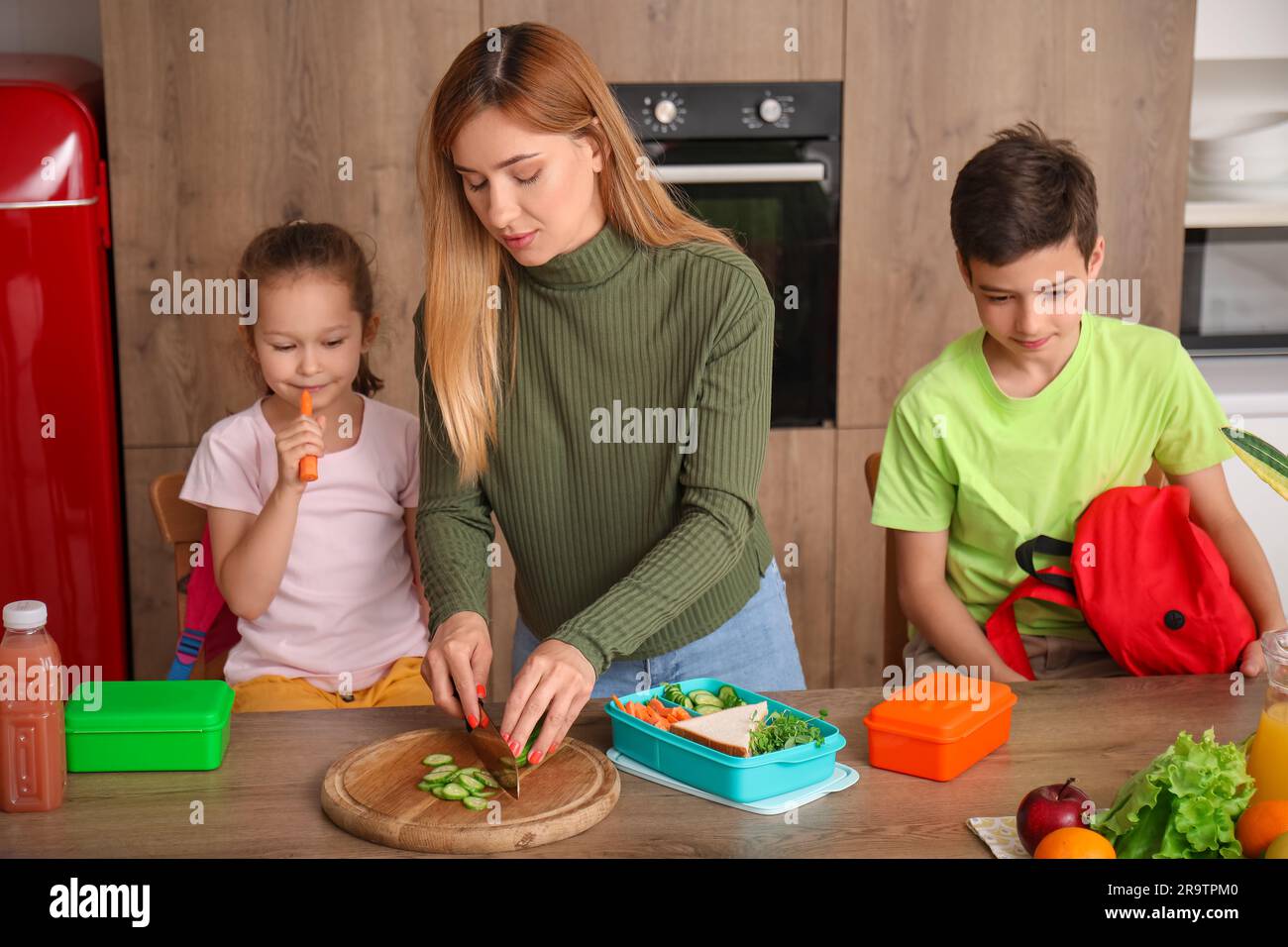 Mother preparing school lunch for her little children in kitchen Stock ...
