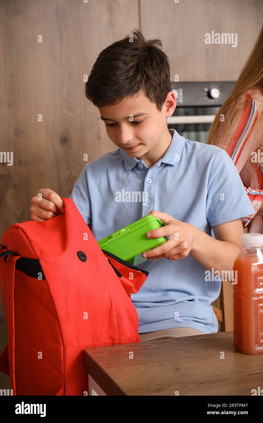 Little boy packing school lunch in kitchen Stock Photo - Alamy
