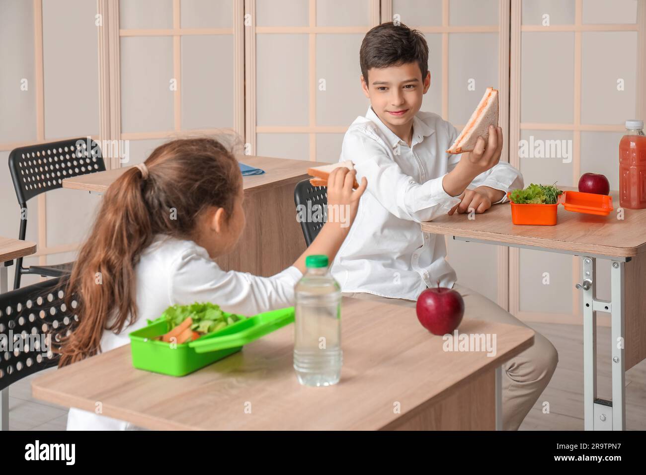 Little children eating lunch in classroom Stock Photo - Alamy