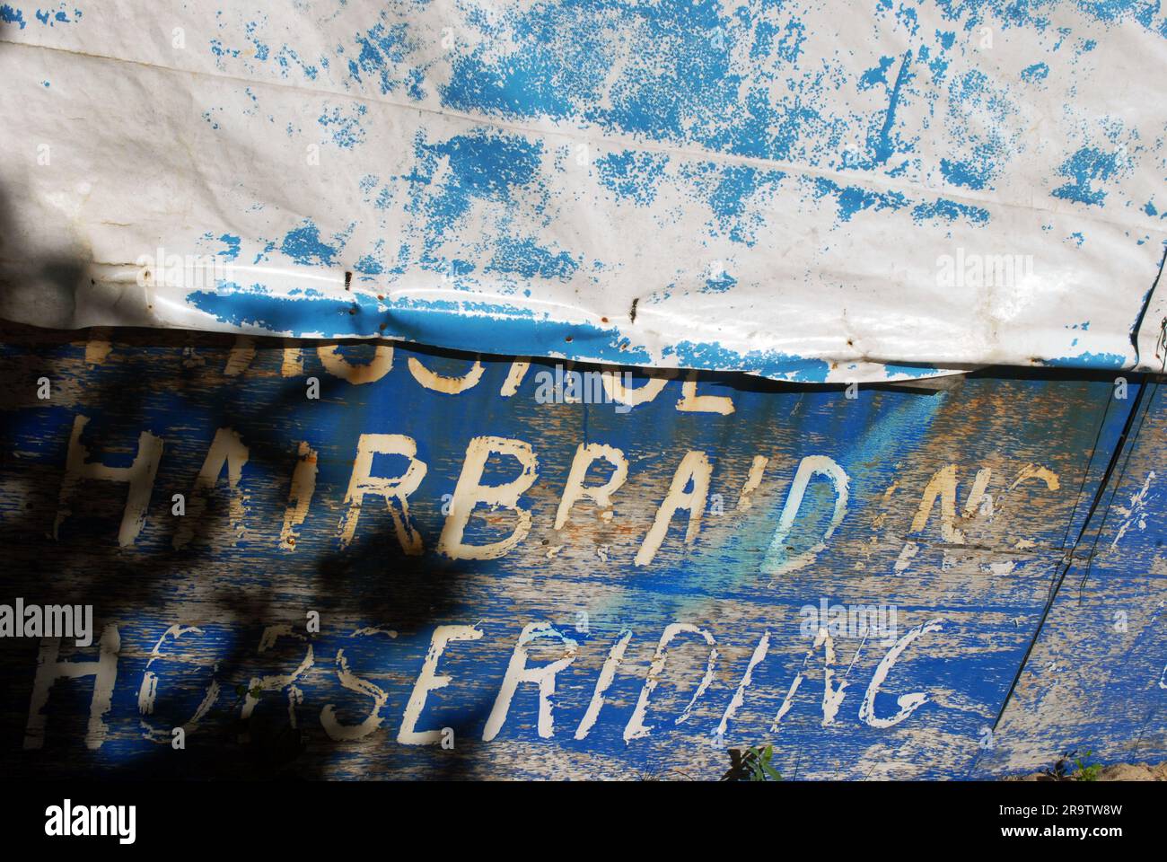 Hand written advertising painted on side of blue hut, Hair braiding and ...