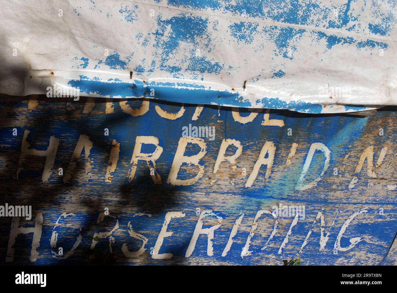 Hand written advertising painted on side of blue hut, Hair braiding and ...