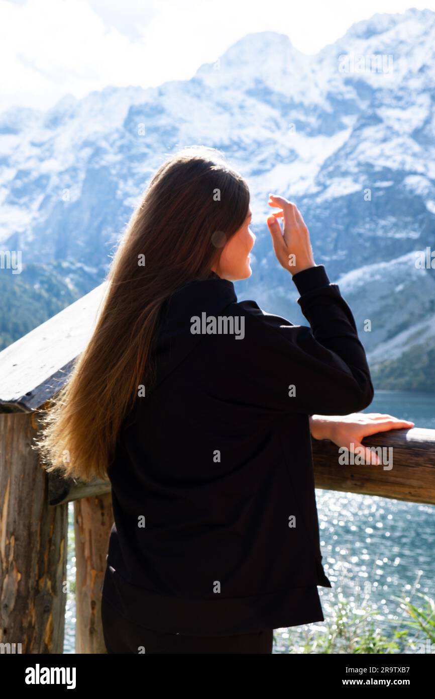 Young woman enjoying nature in Morskie Oko Snowy Mountain Hut in Polish ...