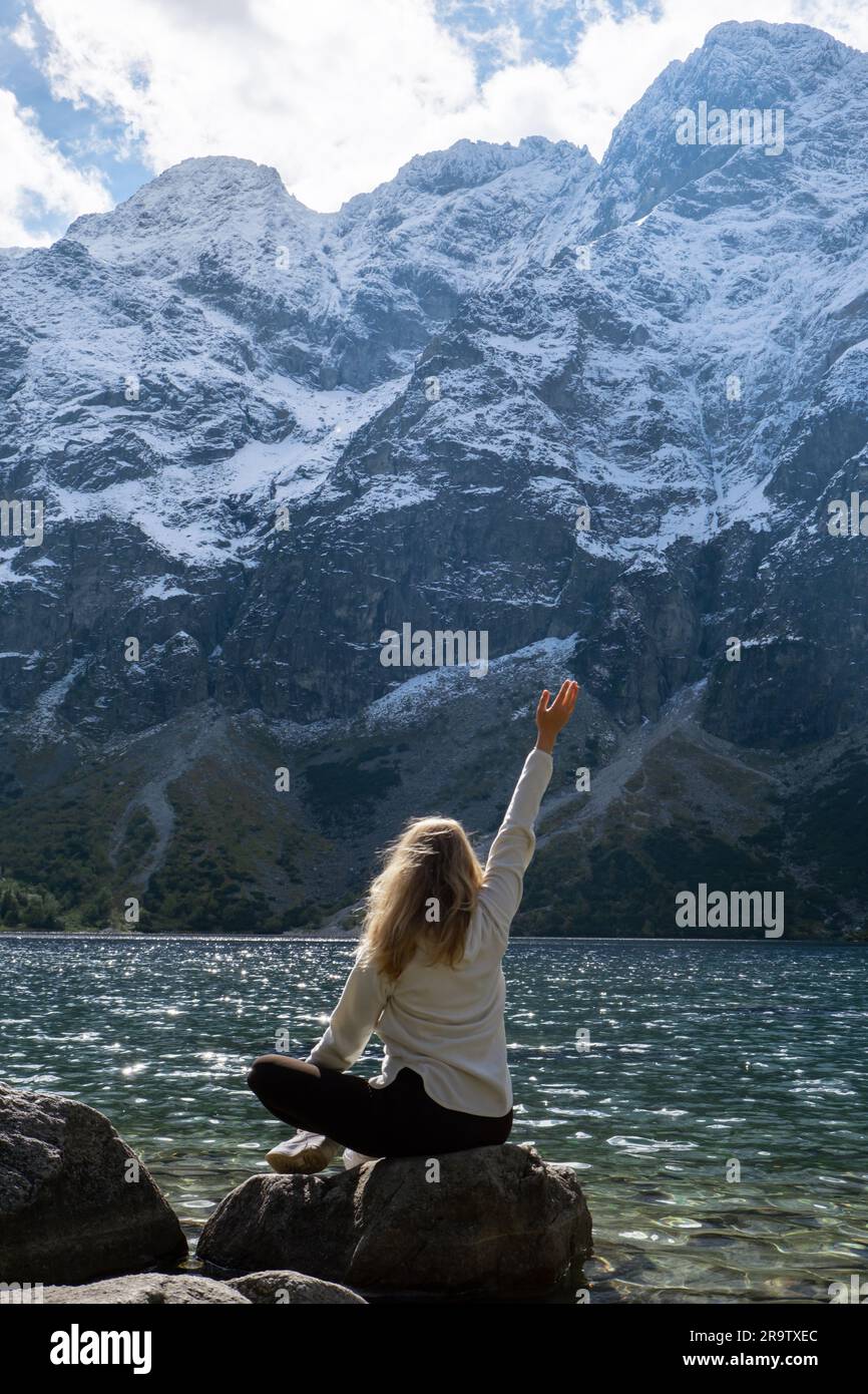 Young woman enjoying nature in Morskie Oko Snowy Mountain Hut in Polish ...