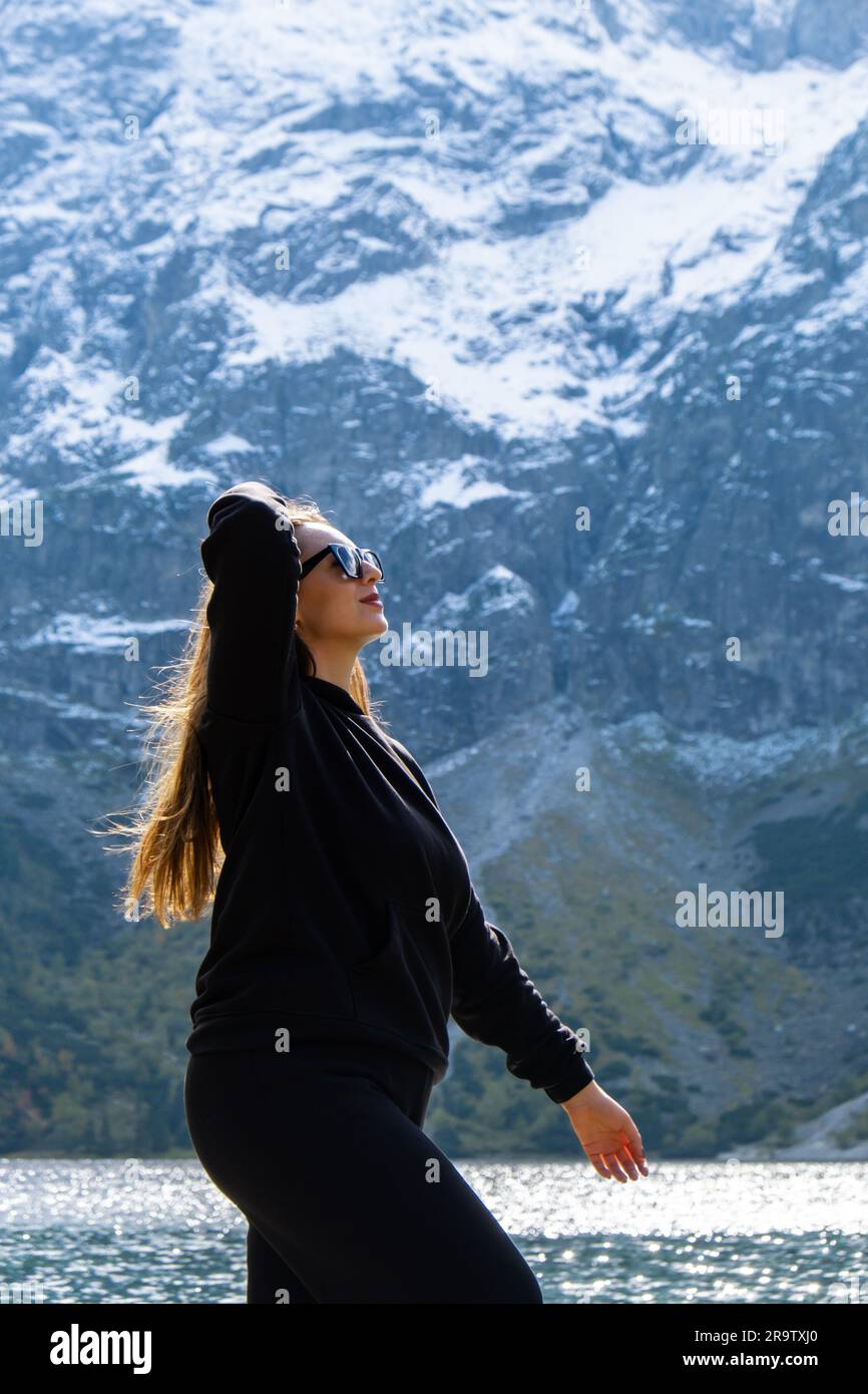 Young woman enjoying nature in Morskie Oko Snowy Mountain Hut in Polish ...