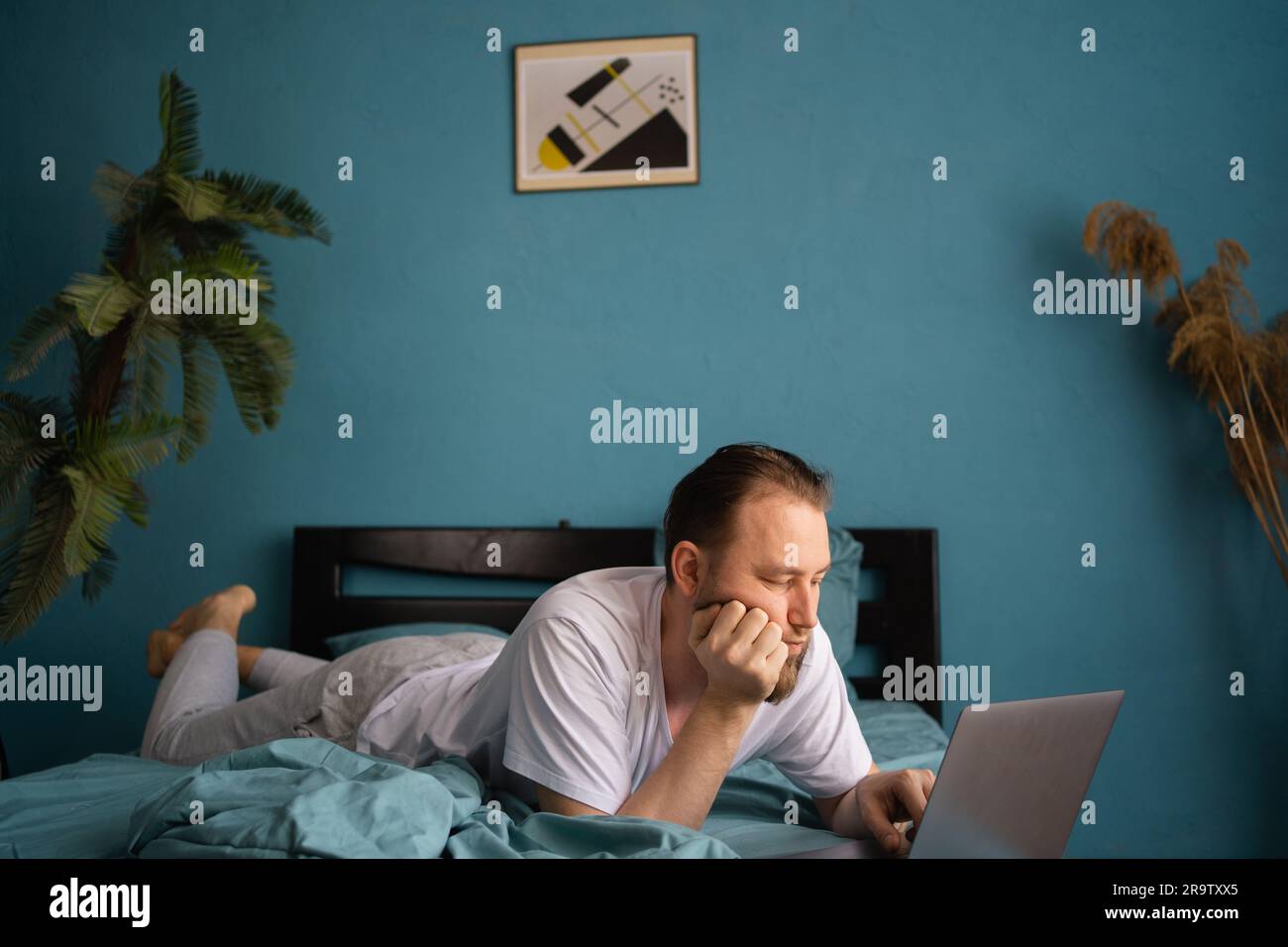 Man in bed watching something hi-res stock photography and images - Alamy