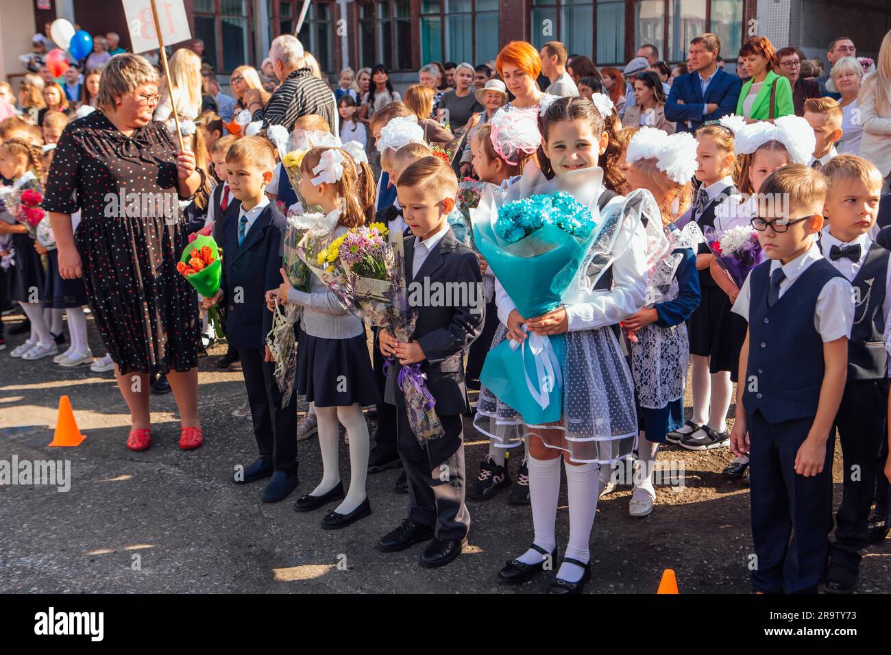 Meeting with the first-grade pupils and teacher at schoolyard. The day ...