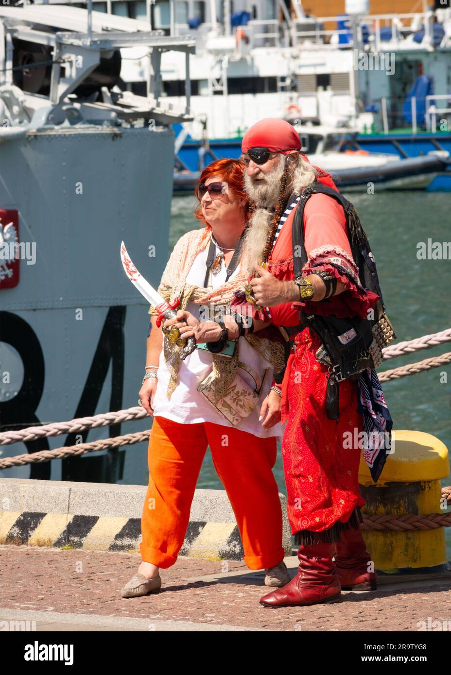 Pirate street performer posing for photo with a female tourist at the ...