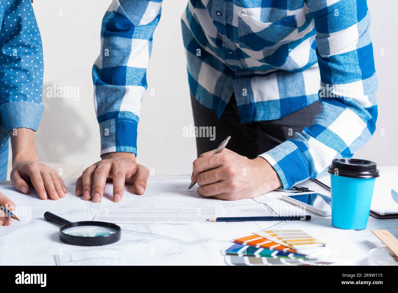 Man carefully studying technical drawing Stock Photo - Alamy