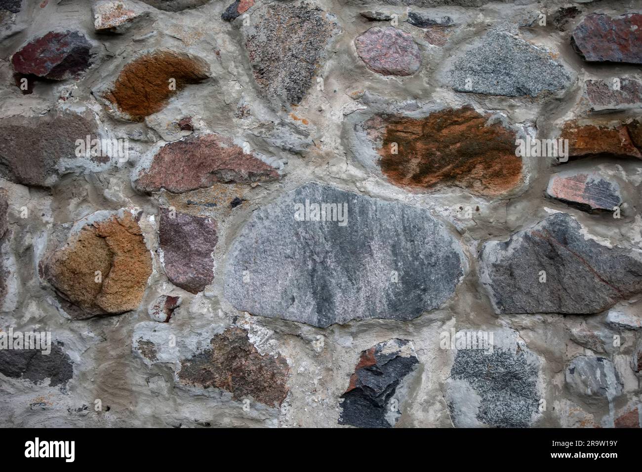 An ancient stone wall consisting of stones of different shapes and ...