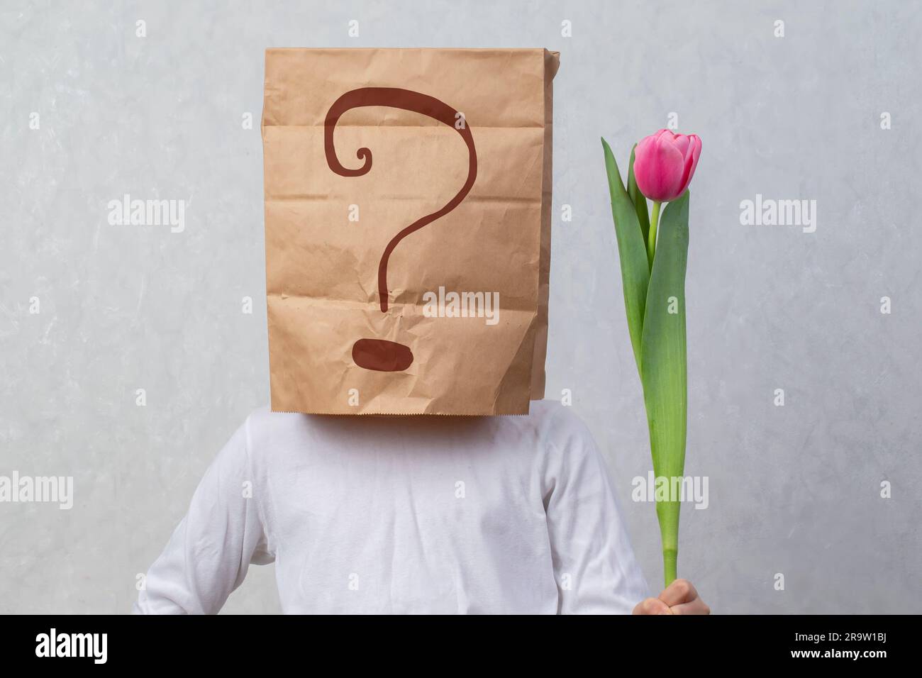 An anonymous man with a box on his head that limits his identity holds ...