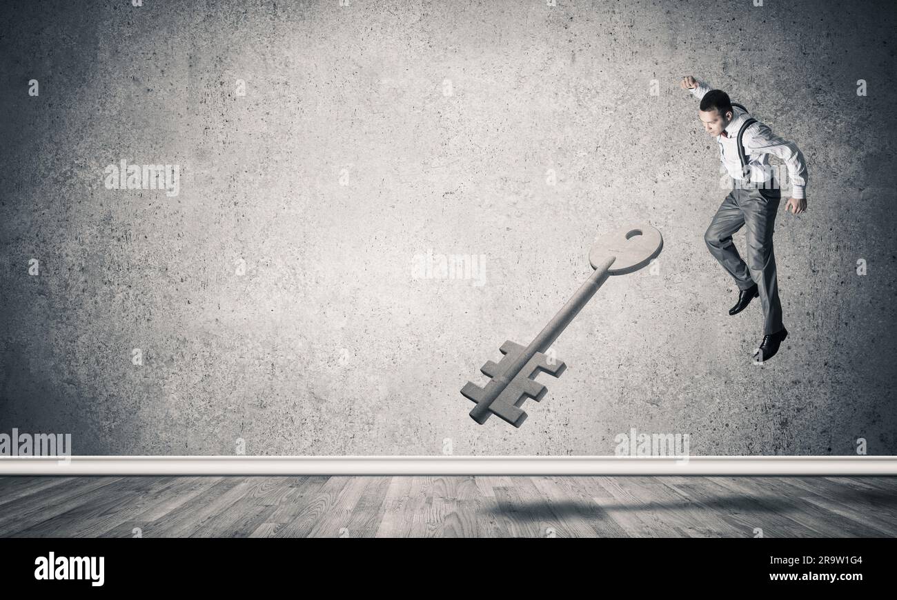 Breaking through access concept with man in room crashing concrete key ...
