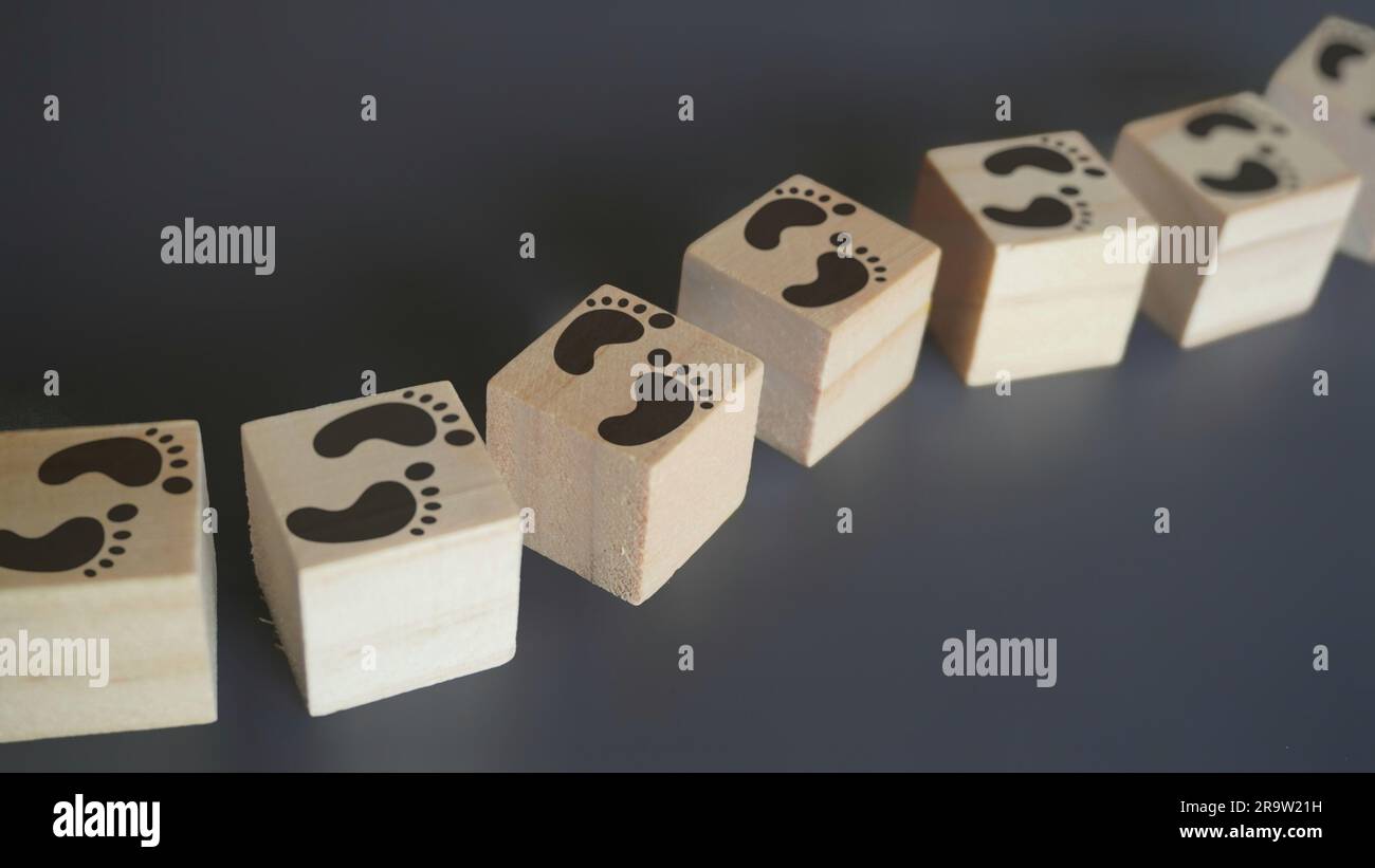 Wooden blocks with footsteps icon and copy space. Progress, step by ...