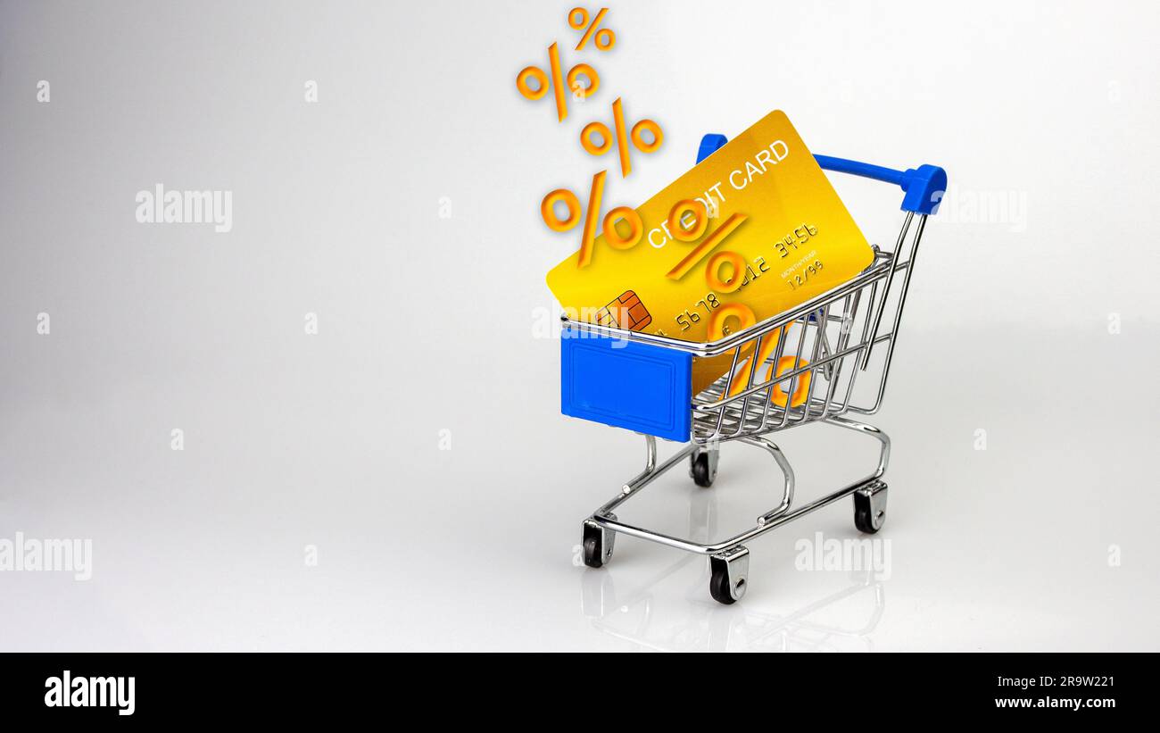 Sale percentage falling in shopping cart and credit card on white ...
