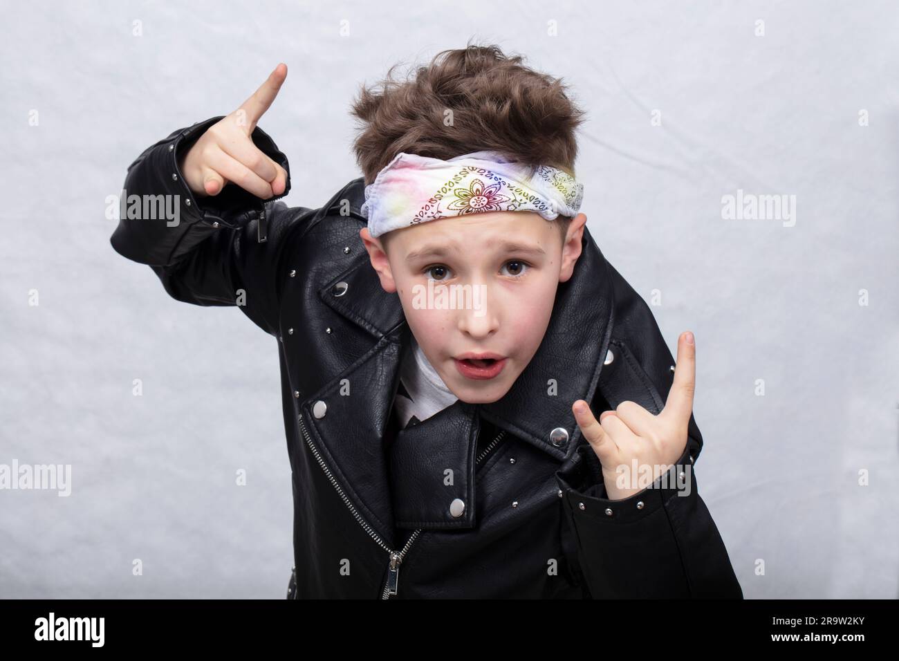 Portrait of a heavy metal boy in sunglasses. Cute teenager in a leather ...