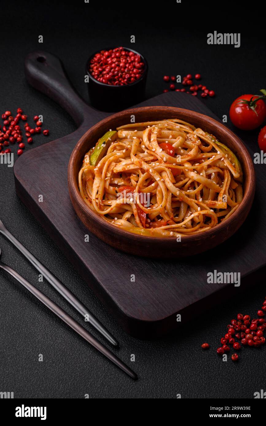Delicious asian udon dish with vegetables, mushrooms, salt and spices ...