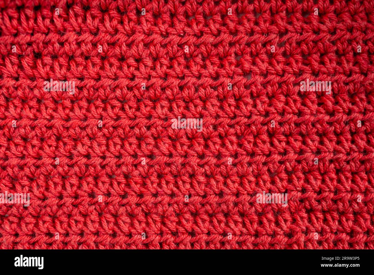 Hand made crochet pattern, textured red abstract background, with ...