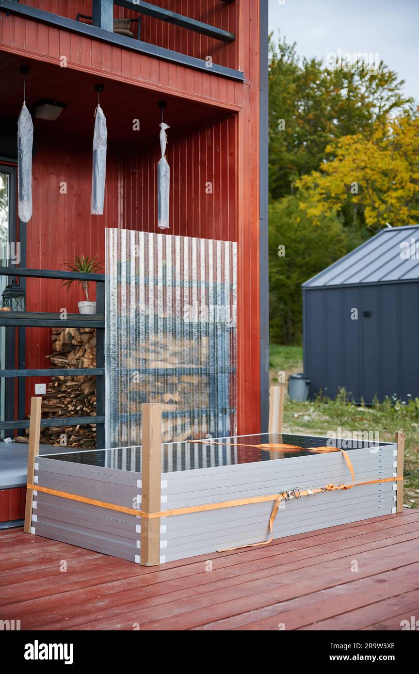 Solar panels prepared for installation, lying on the terrace of modern ...