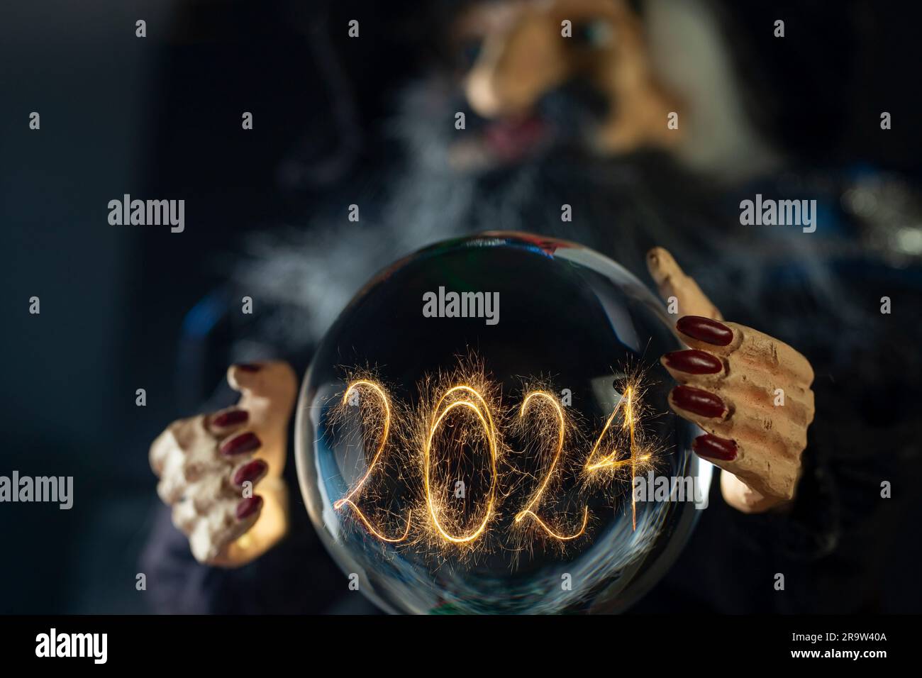 2024 written with sparklers and sparks lettering , inside a crystal ...