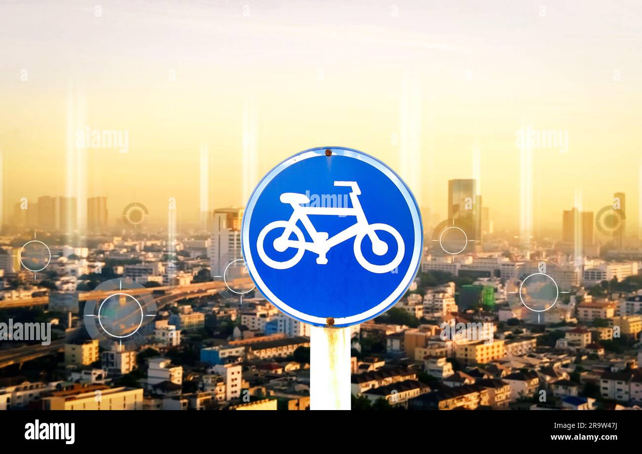 Bicycle road sign with cityscape background at sunset, transportation ...