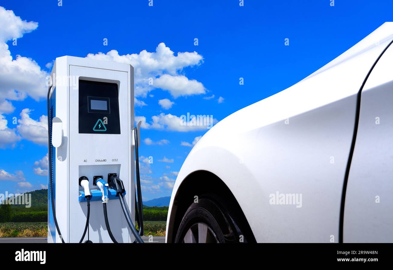 Electric car charging station with blue sky and clouds background. EV ...
