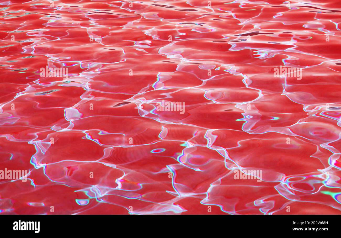 Eye-catching surreal pop art of red colored water surface reflecting ...
