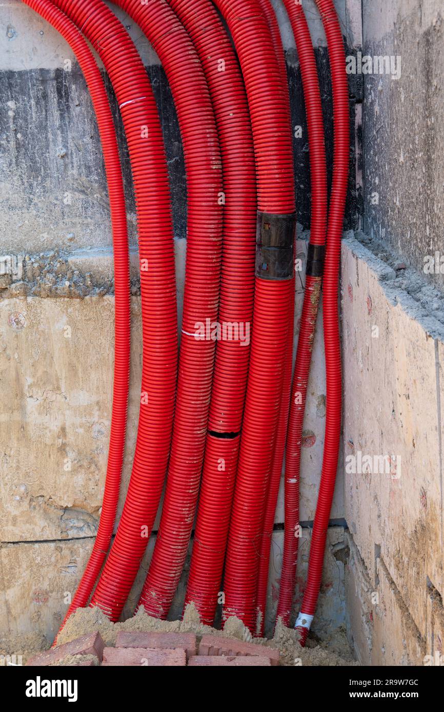 Red plumbing pipe close-up. Drainage, tubing, pipes. Red pipes of the ...