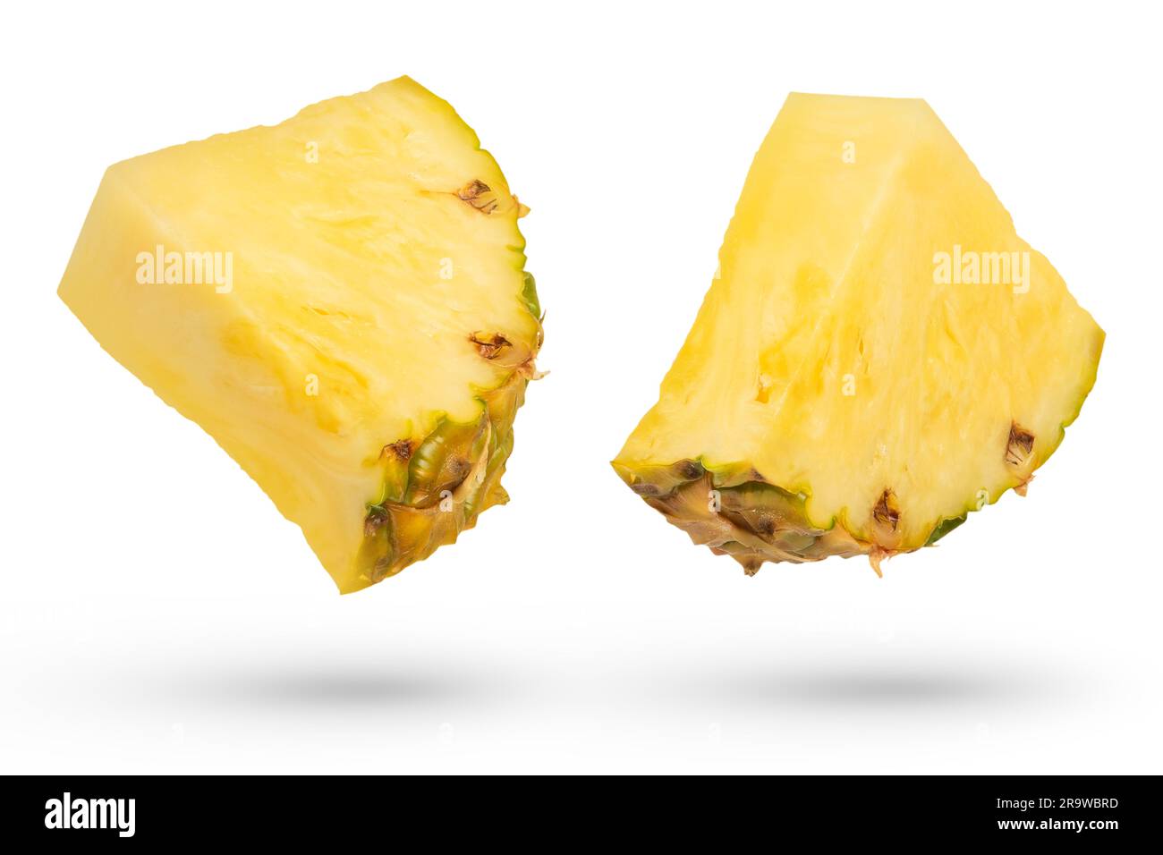 Pieces of ripe pineapple on a white isolated background. Pieces and ...