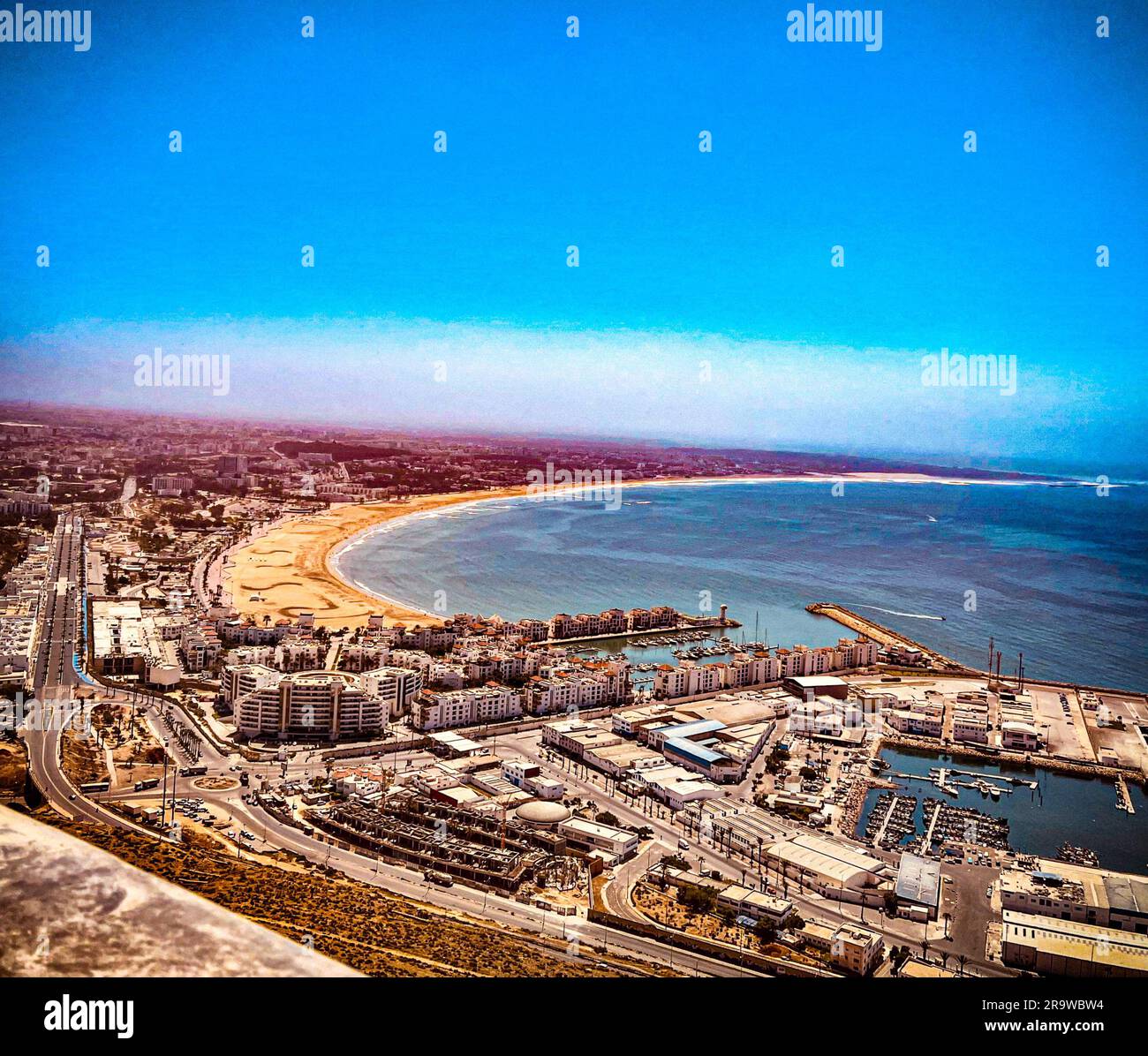 An aerial view of cityscape Agadir surrounded by buildings and water ...