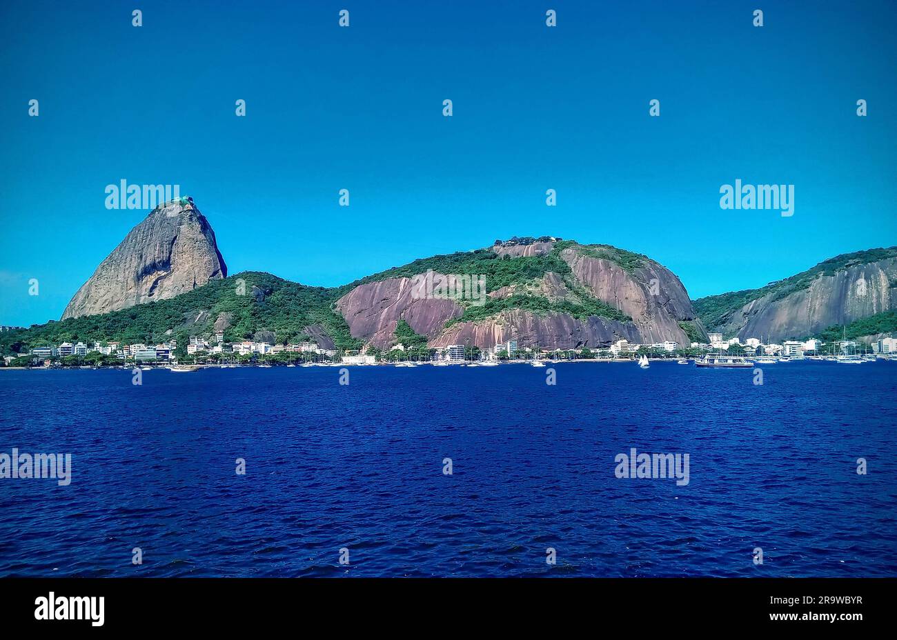 An aerial view of sea with beach surrounded by buildings in Rio de ...