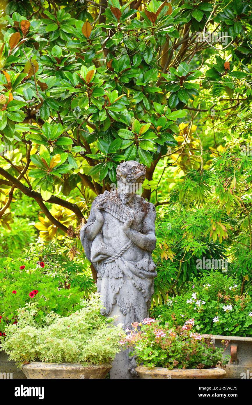 Statue of Pan playing his flute in the RHS gardens at Wisley Stock ...