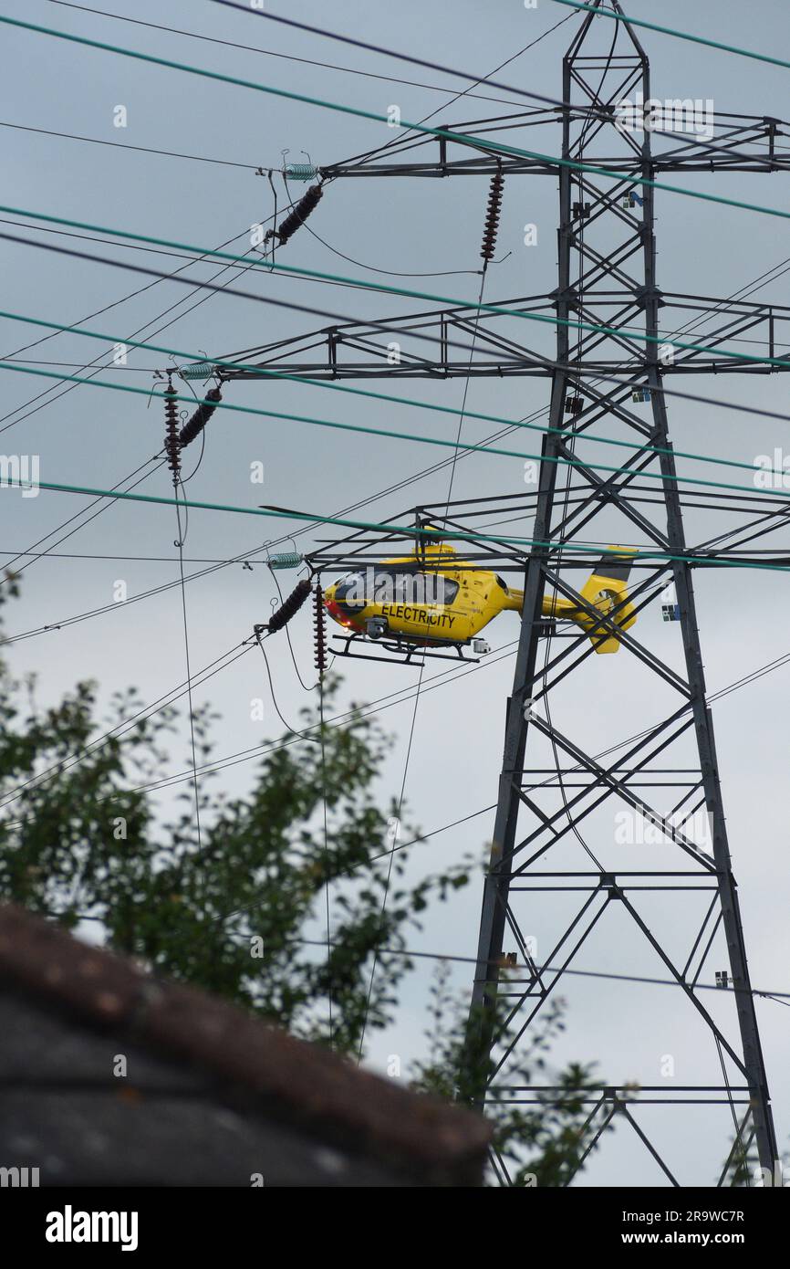 Yellow Airbus Helicopter close to high power lines Stock Photo - Alamy