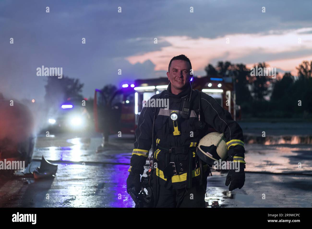 Portrait of a heroic fireman in a protective suit. Firefighter in fire ...