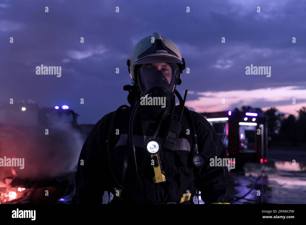 Portrait of a heroic fireman in a protective suit. Firefighter in fire ...