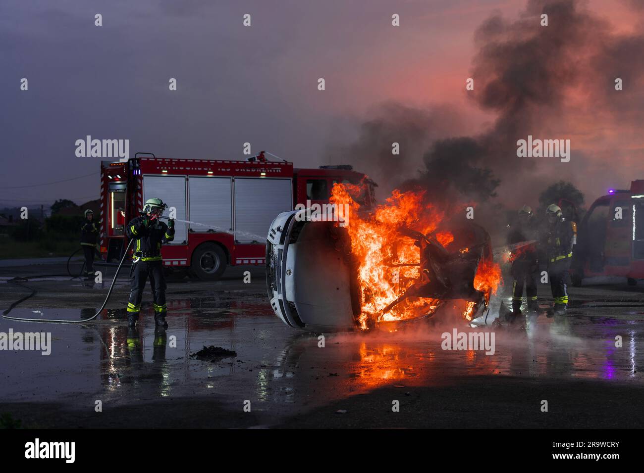 Firefighters fight the fire flame to control fire not to spreading out ...