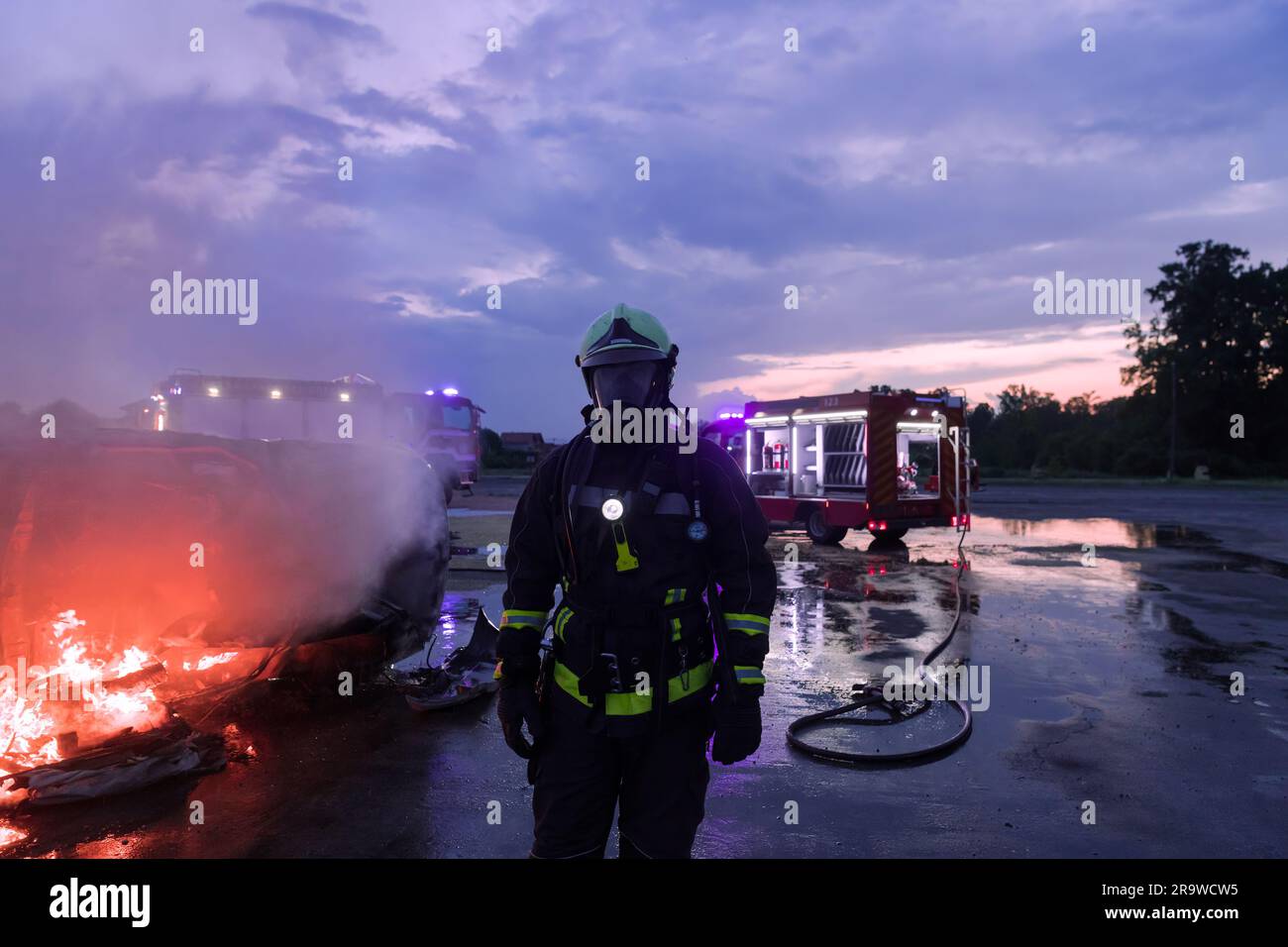 Portrait of a heroic fireman in a protective suit. Firefighter in fire ...