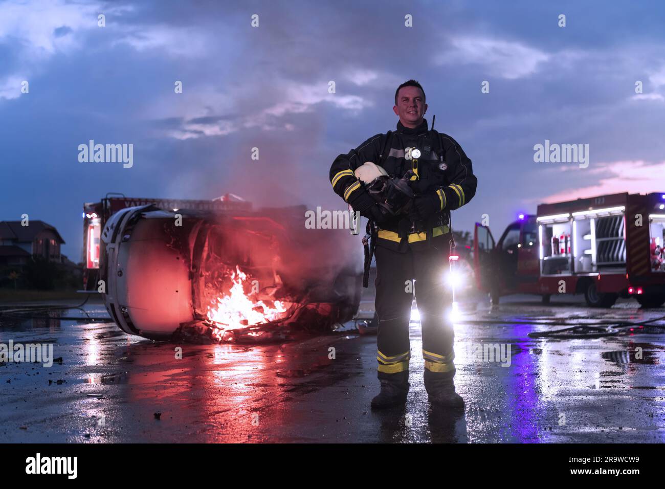 Portrait of a heroic fireman in a protective suit. Firefighter in fire ...