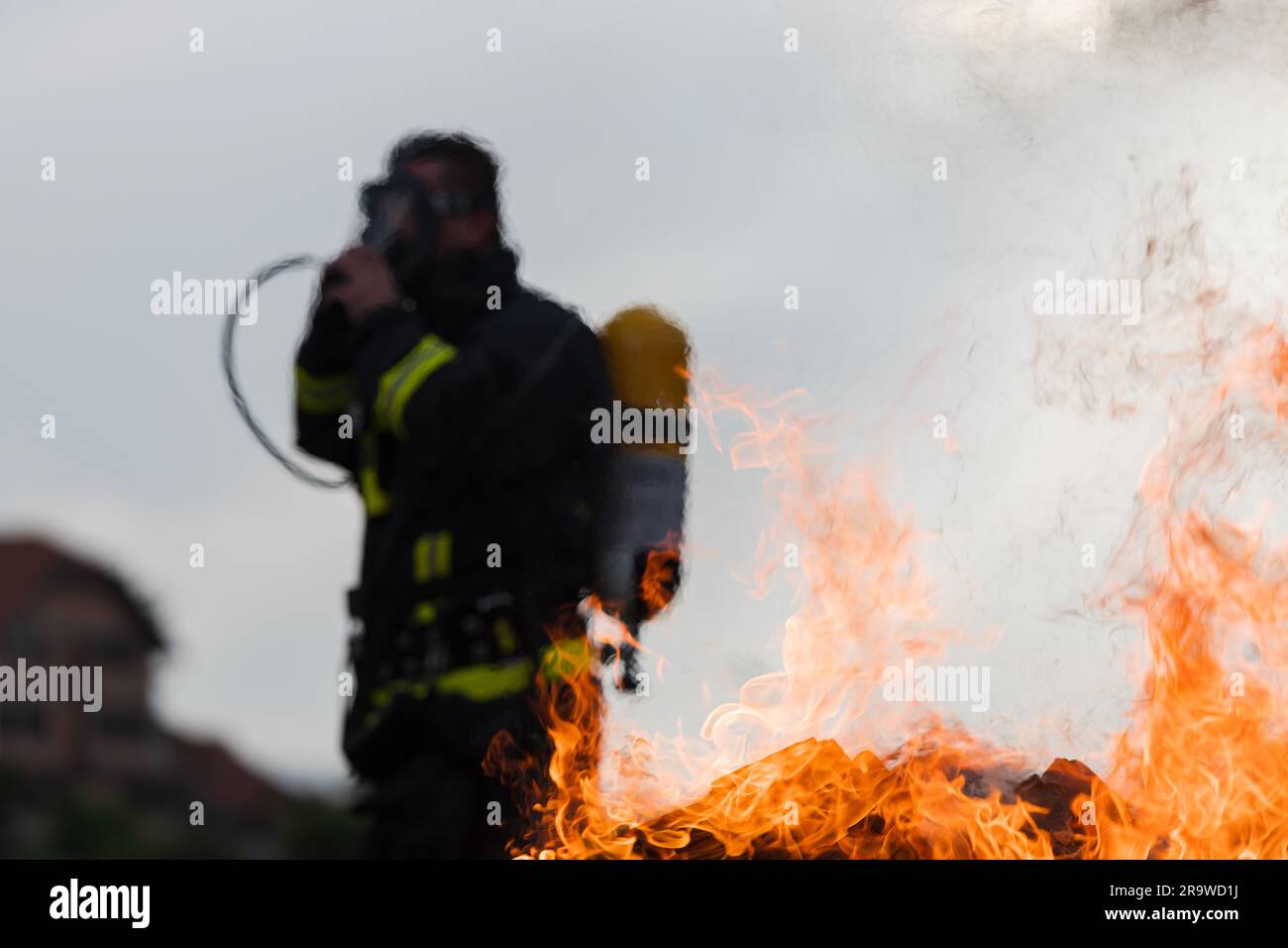Portrait of a heroic fireman in a protective suit. Firefighter in fire ...